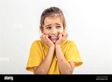Scared And Anxious Girl Biting Her Fingernails On A White Background