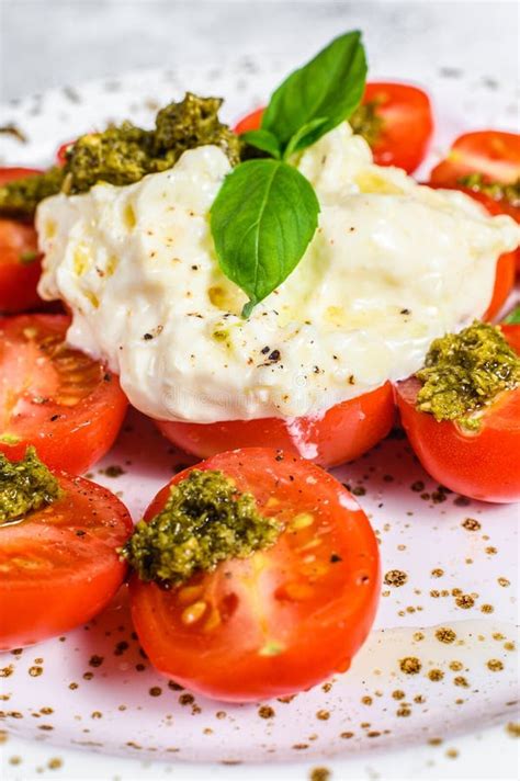 Italian Cheese Stracciatella Burrata On Small Plate Served With Fresh Tomatoes And Basil Gray