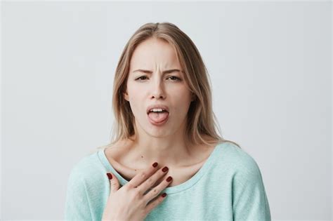 Free Photo Dissatisfied Blonde Female Model Frowns Face Has Disgusting Expression Shows