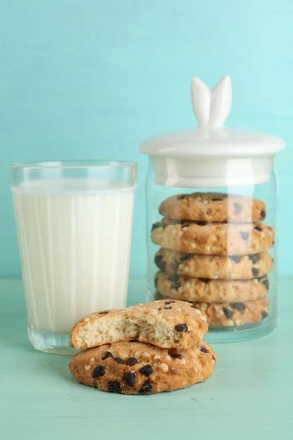 Premium Photo Tasty Cookies And Glass Of Milk On Color Wooden Background