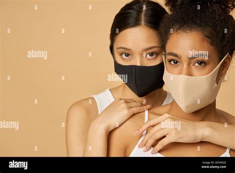 Two Attractive Young Women Female Friends Wearing Protective Facial