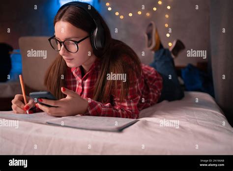 Teen Girl Student With Cell Phone For Distance Learning Using Mobile Application Watching