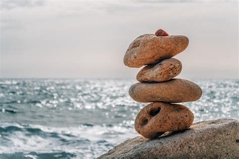 Premium Photo Balanced Pebble Pyramid On The Beach On A Sunny Day Sea