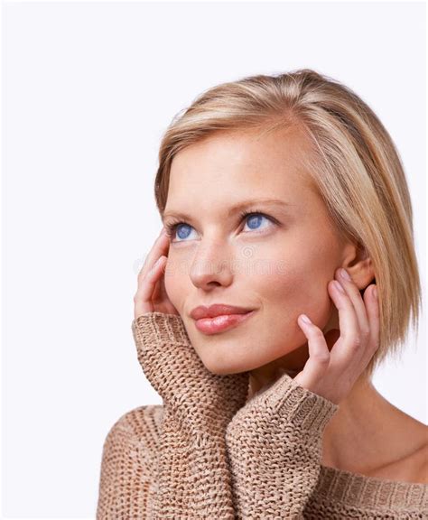 Pure And Beautiful Studio Shot Of An Attractive Young Woman Touching