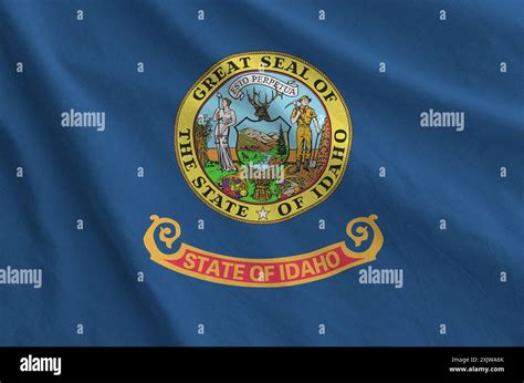Idaho Us State Flag Depicted On Folded Wavy Fabric Of Old Cloth Close