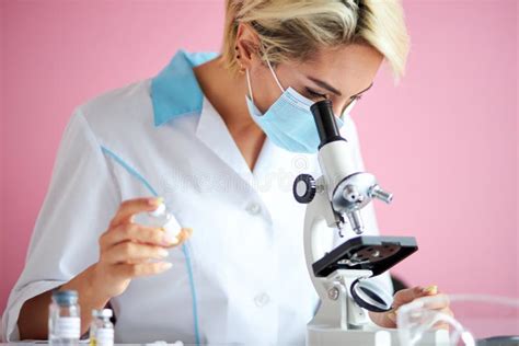 Female Scientist Holding Sampling Oil Or Chemical Liquid In Flask With Lab Glassware In