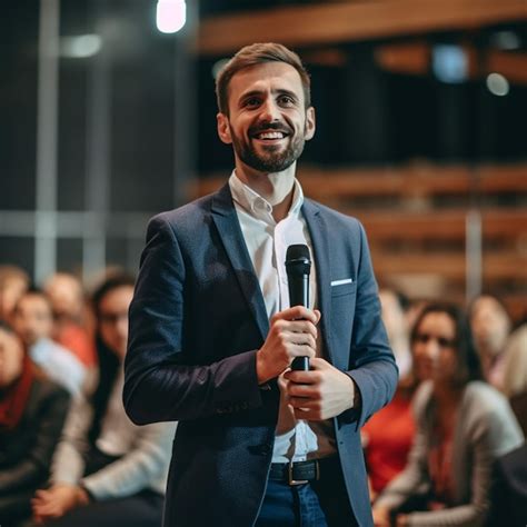 A Man In A Suit Is Holding A Microphone In Front Of A Crowd Premium AI Generated Image