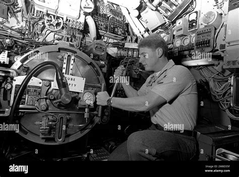 A Petty Officer Opens The Breach Door Of A Torpedo Aboard The Attack