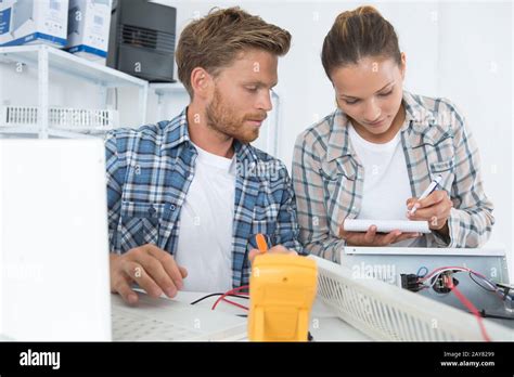 Couple Measuring Voltage Stock Photo Alamy