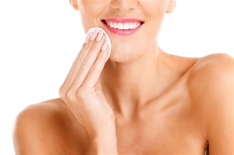 Premium Photo Sensual Woman Removing Makeup Over White Background