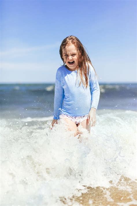 Young Girl Playing On The Beach In Waves At Summer Stock Image Image