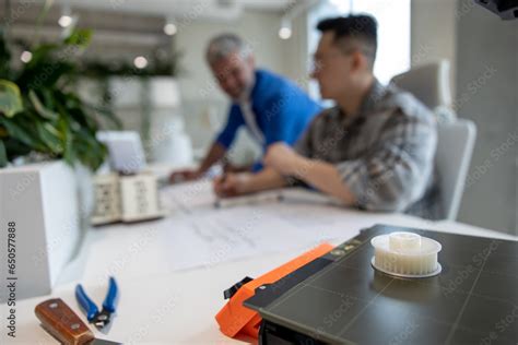 Two Men Architects Using 3D Printer In Office And Projecting House