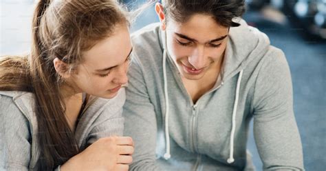 현대 체육관에서 이야기하고 쉬고 물을 마시고 스마트 폰을 들고 무언가를 보는 아름다운 젊은 커플 사진 Unsplash의 크로스핏 이미지