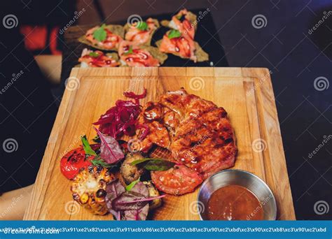 Well Done Grilled Marinated Beef Flank Steak On Wooden Board Stock
