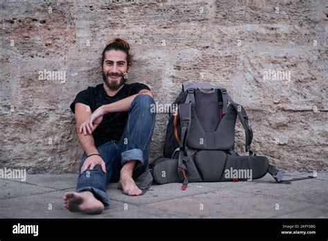 Caucasian Guy With Beard Long Hair Barefoot Happy And Content Sitting
