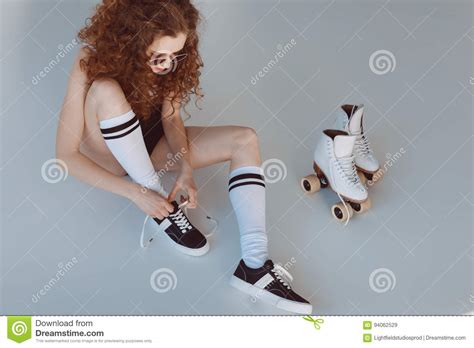 High Angle View Of Hipster Girl In Sunglasses Wearing Roller Skates