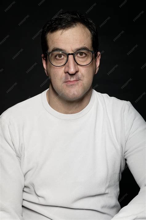 Premium Photo Portrait Of Man Wearing Eyeglasses Against Black Background