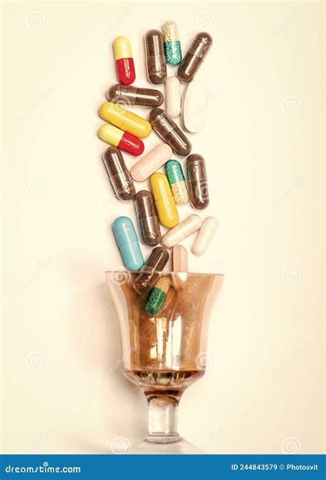 Medicinal Drugs And Medications Colorful Caplets Spill Over Glass