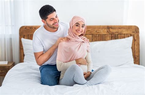 Caring Man Massaging Feet Of His Wife While They Relaxing On Couch