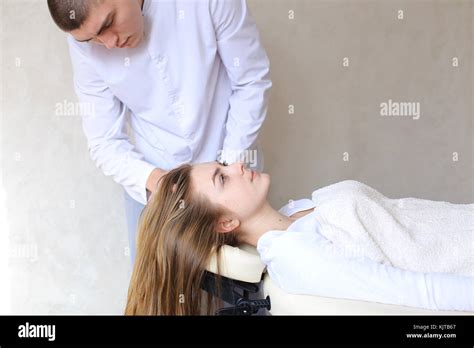 Handsome Guy Massage Therapist Doing Head Massage For Girl Clien Stock