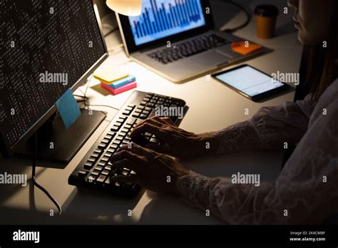 Hands Of Biracial Female Programmer Sitting At Desk Using Computer With Coding On Screen