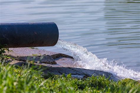 Premium Photo The Pipe Discharges Water Into A Natural Reservoir