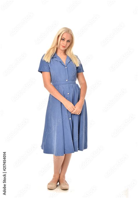 Full Length Portrait Of Blonde Girl Wearing Blue Dress Standing Pose