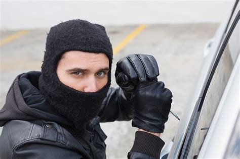 Premium Photo Thief Breaking Into A Car