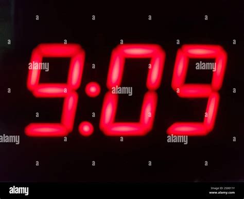 A Digital Clock Face Showing The Time In Red Numbers On A Black
