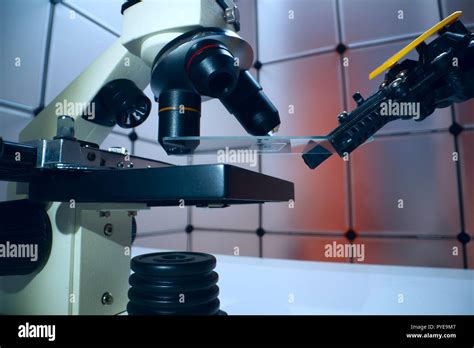 Microscope Slide In Robot Arm And Science Microscope Stock Photo Alamy