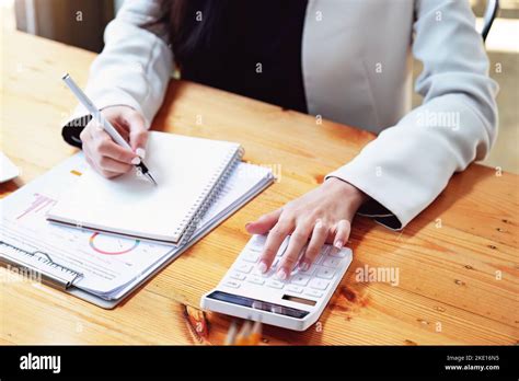 Financial Planning Marketing And Accounting Asian Woman Economist Using Calculator To