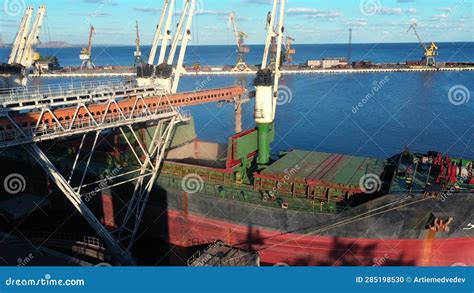 Aerial Of Wheat Loading To Bulker Ship Cargo Hold At Sea Grain Elevator