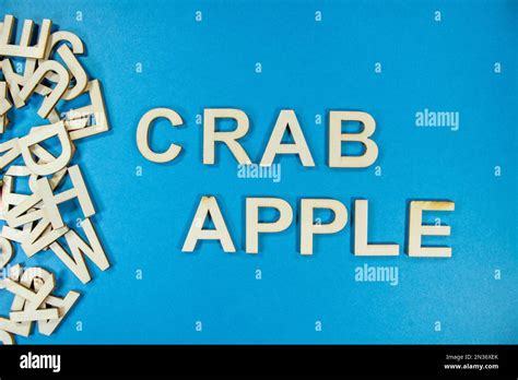 Crab Apple Fruit In Wooden English Language Capital Letters Spilling
