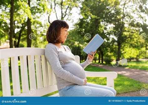 Happy Pregnant Asian Woman Reading Book At Park Stock Image Image Of