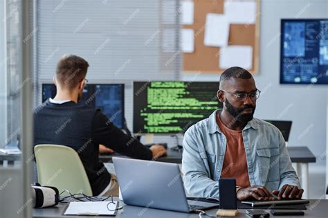 premium photo portrait of black man using computer while programming