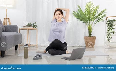 Beautiful Asian Woman In Sportswear Is Warming Up Or Doing Light