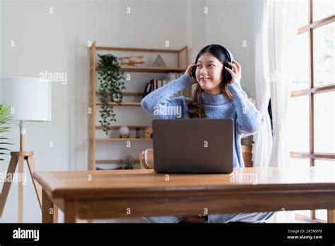 Young Attractive Woman Connecting The Internet With A Laptop At Home