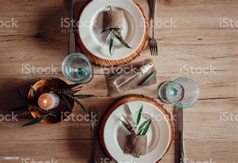손 소독제 병이 중앙에 있는 레스토랑 테이블 세트 잎과 헤더 꽃 장식 흰색 접시 바이러스 확산 예방 새로운 현실 0명에 대한