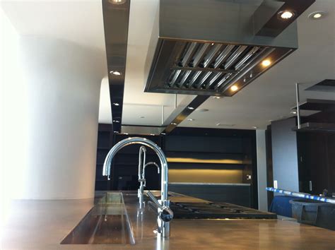 Modern Kitchen Space With Floating Range Hood And 38 Thick Stainless