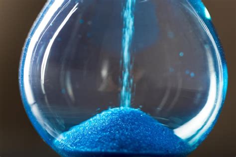 Free Photo Time Is Passing Blue Hourglass Close Up