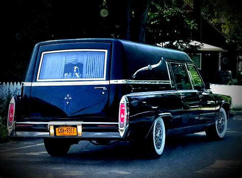An Old Black Car Is Parked On The Street