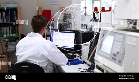 Image Of Circles Spinning Over Male Scientist Using Computer Stock