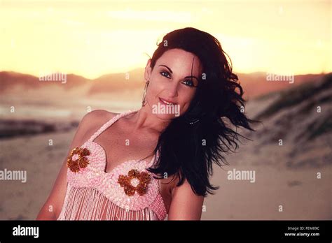 A Beautiful Belly Dancer Is Performing On The Beach In South Africa