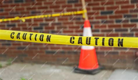 Premium Photo A Caution Cone Is Shown On A Brick Wall