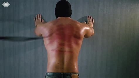 Shirtless Hooded Man Gets Whipped