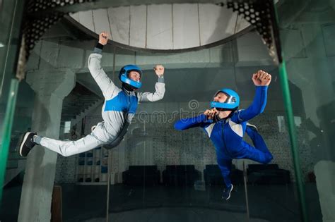 A Man And A Woman Enjoy Flying Together In A Wind Tunnel Free Fall Simulator Stock Image