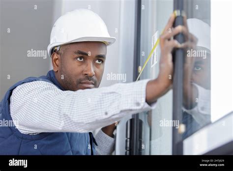 Man Measuring Window Prior To Installation Of Roller Shutter Outdoors Stock Photo Alamy