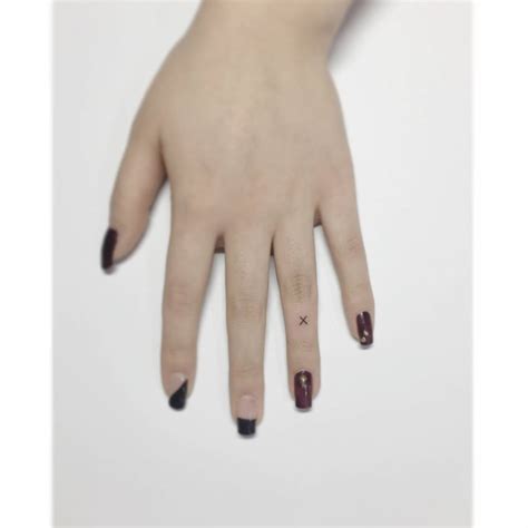 Tiny Letter X Tattoo Located On The Finger