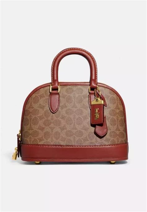 Jual Coach Coach Revel Bag In Signature Canvas Tan Rust Original 2025
