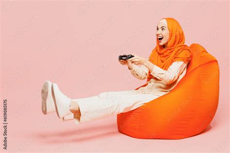 Full Body Young Arabian Asian Muslim Woman Wear Orange Abaya Hijab Sit